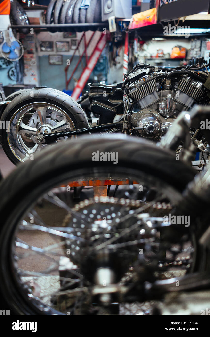 Row of disassembled motorcycles set for tuning up and customizing in ...