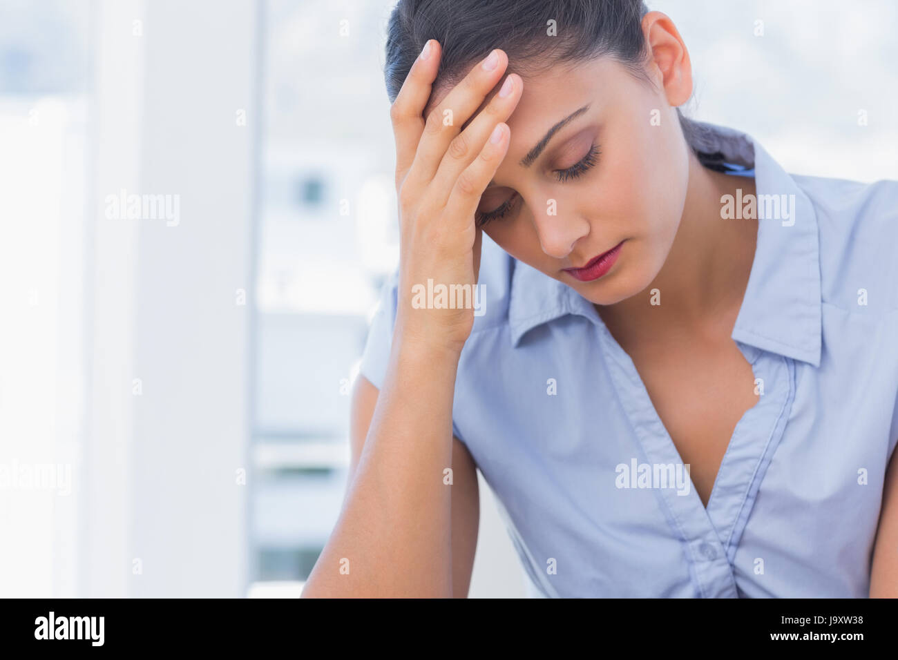 Concerned businesswoman getting annoyed with her work Stock Photo - Alamy