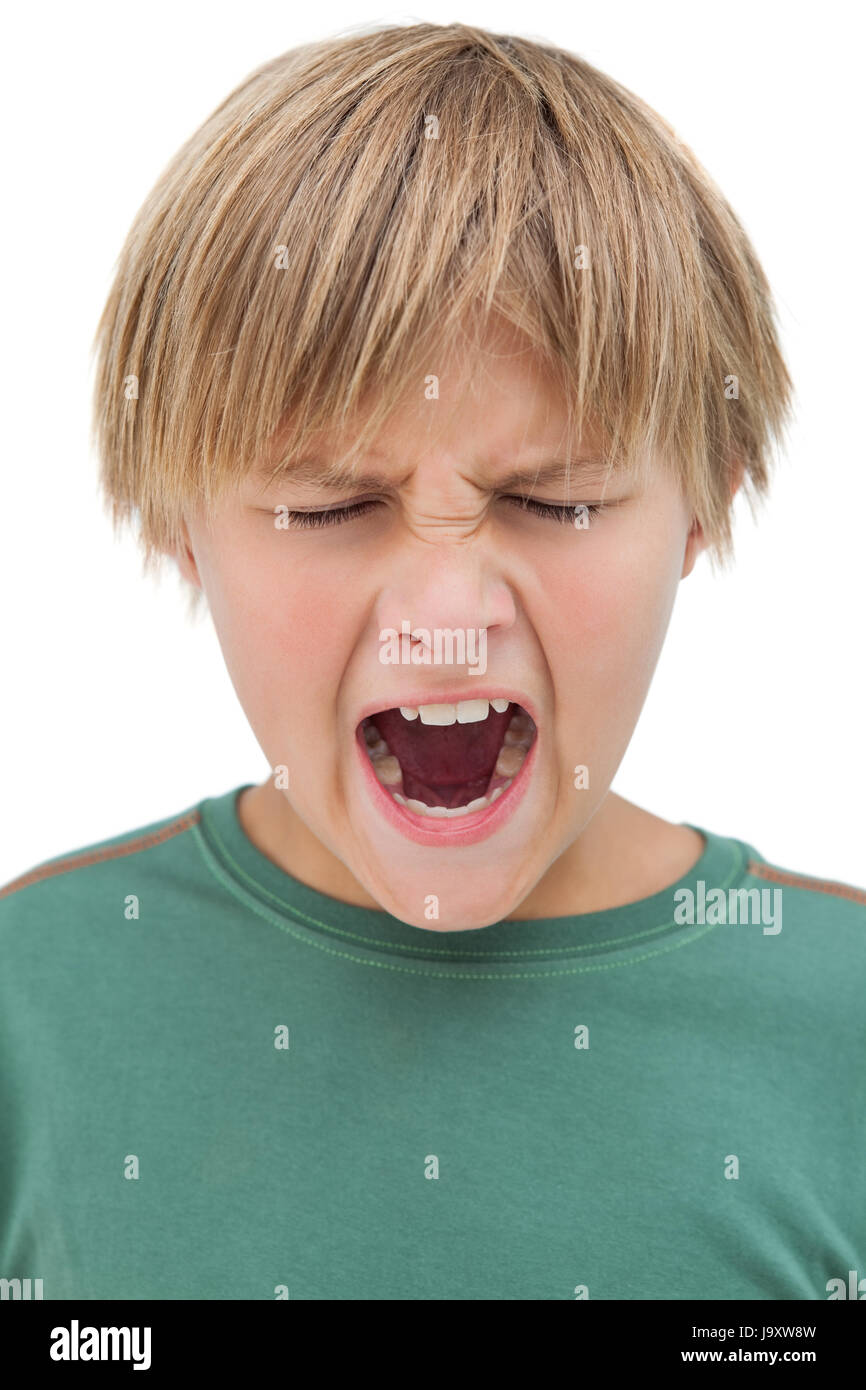 Furious little boy shouting with eyes closed on white background Stock ...