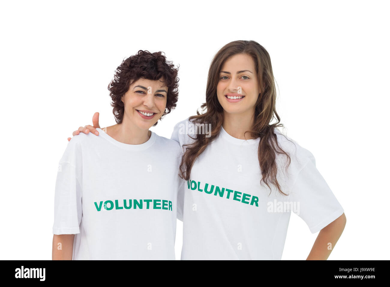 Two cheerful volunteers standing on white background Stock Photo - Alamy
