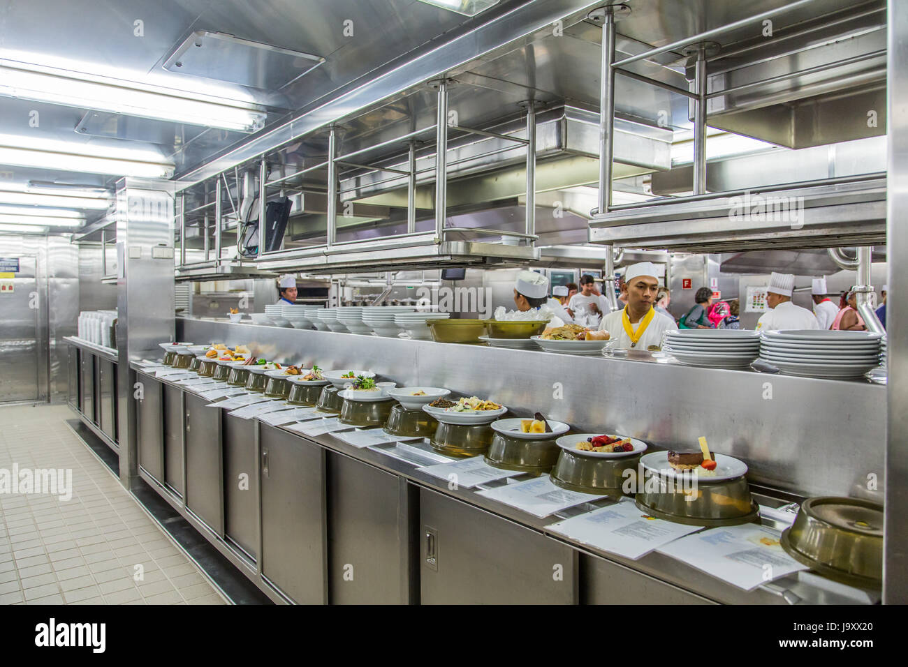 Plates of food being prepared in a commercial kitchen Stock Photo - Alamy
