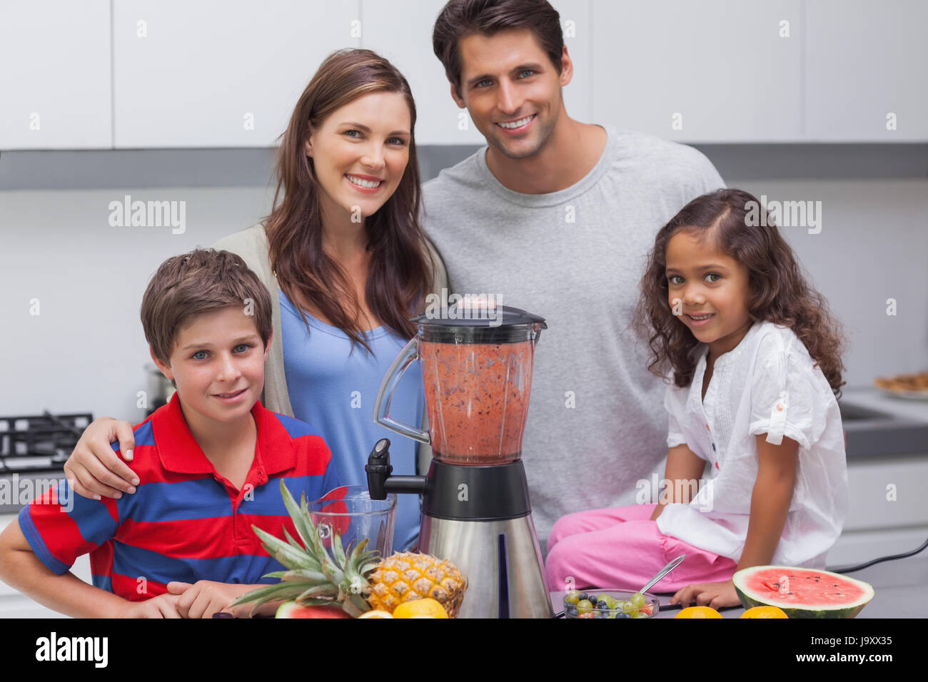 Family posing with a blender in the kitchen Stock Photo - Alamy