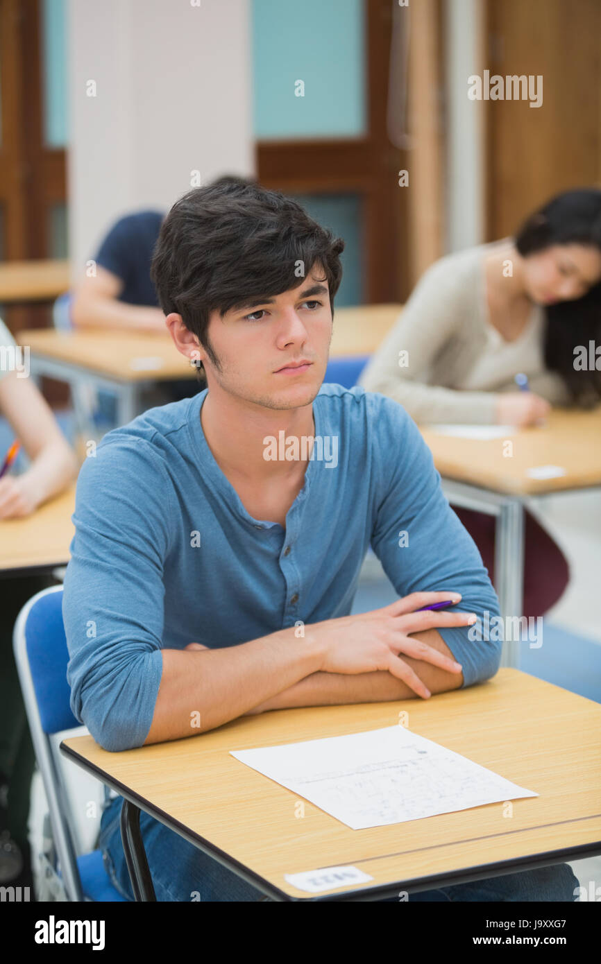 Student looking up during exam in exam hall Stock Photo - Alamy