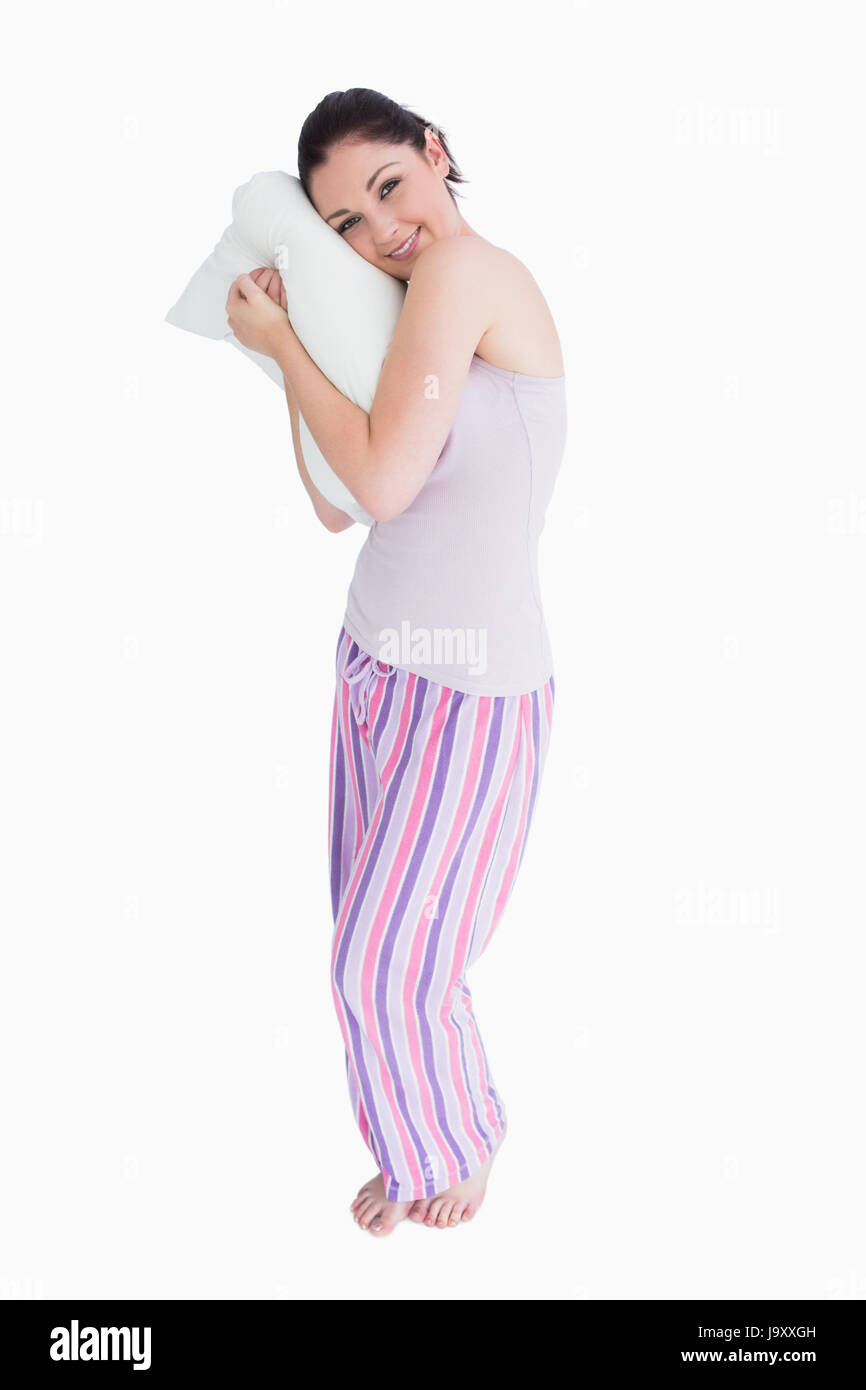 Standing woman relaxing on her comfortable pillow on white background ...