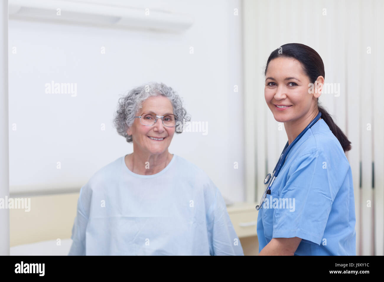 Nurse assisting a patient in hospital ward Stock Photo - Alamy