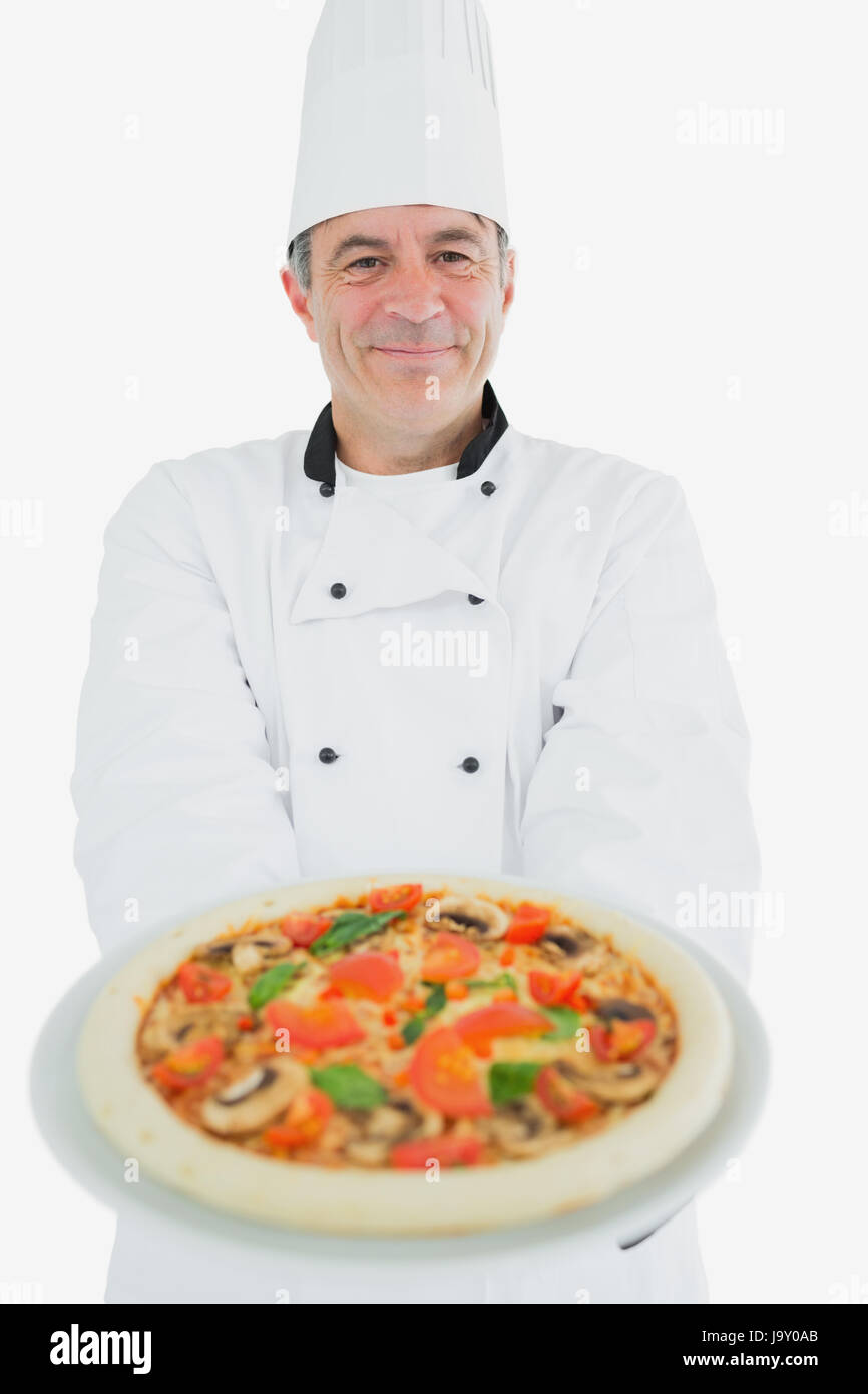 Portrait of happy chef offering pizza over white background Stock Photo ...