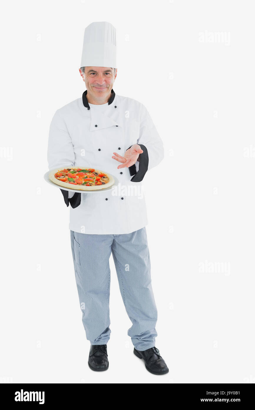 Full length portrait of male chef displaying pizza over white ...