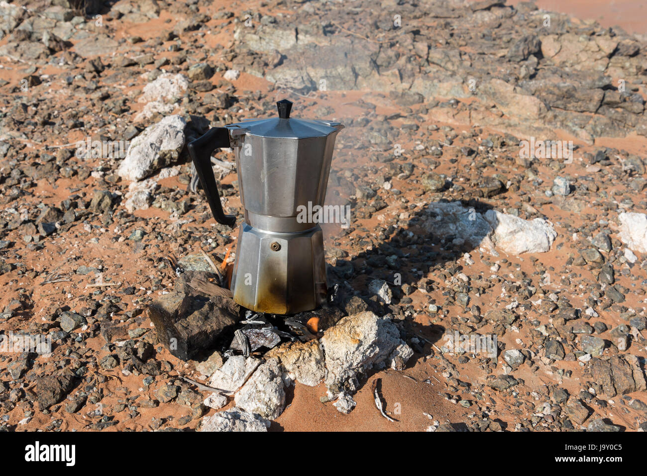 Italian Coffee maker boiling at a fireplace in the desert Stock Photo ...