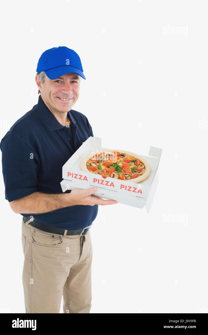 Portrait of cheerful pizza delivery man standing against white ...