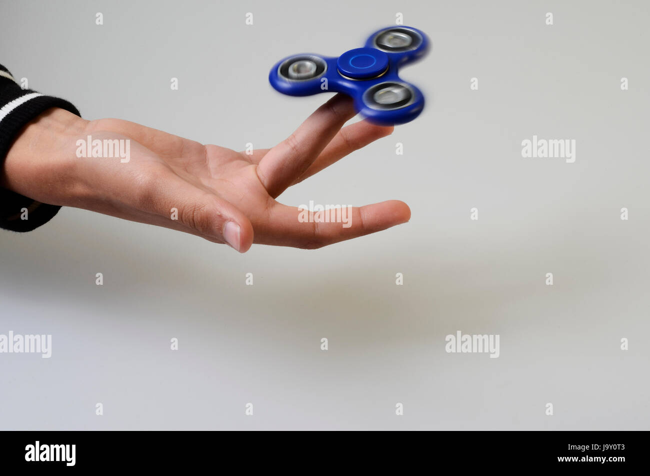 Blue Hand spinner, fidgeting hand toy Stock Photo - Alamy Blue Hand spinner, fidgeting hand toy Stock Photo - Alamy