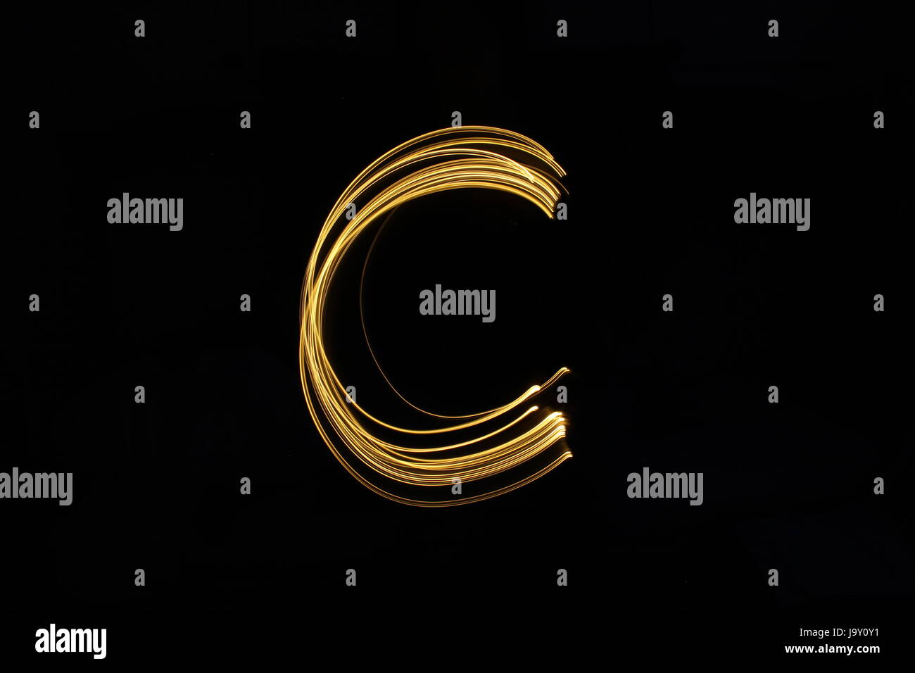 Gold fairy lights - Letter C - Light Painting Photography against a ...