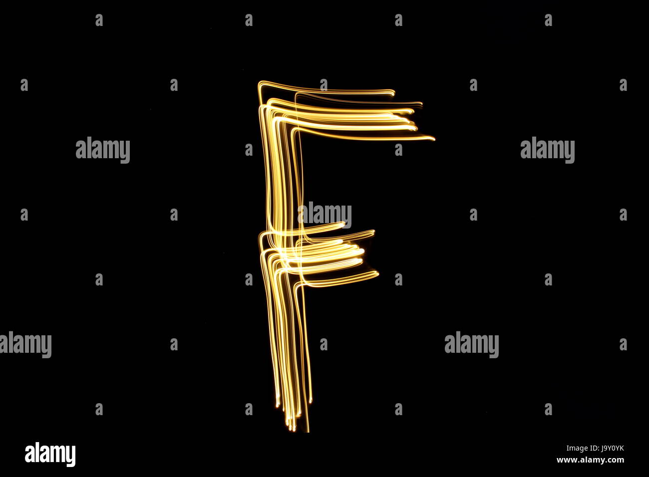 Gold fairy lights - Letter F - Light Painting Photography against a ...