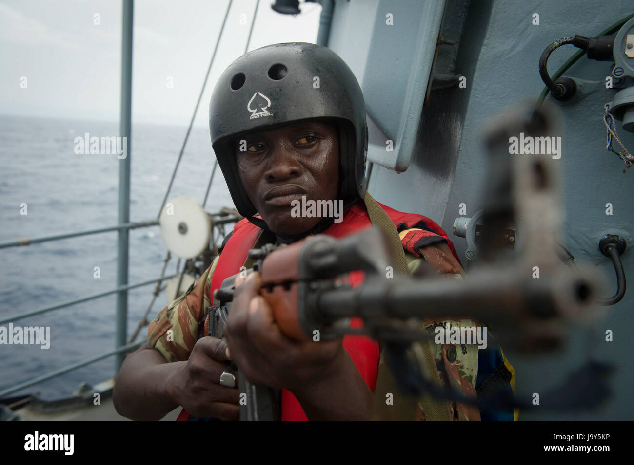 A Beninese soldier provides security aboard the German Navy Type F123 ...
