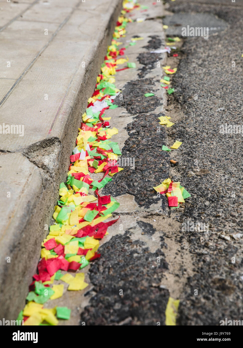 Rest of confetti on the street after the party Stock Photo - Alamy