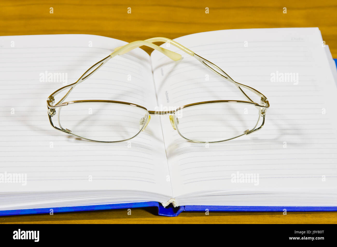 notebook and glasses Stock Photo - Alamy