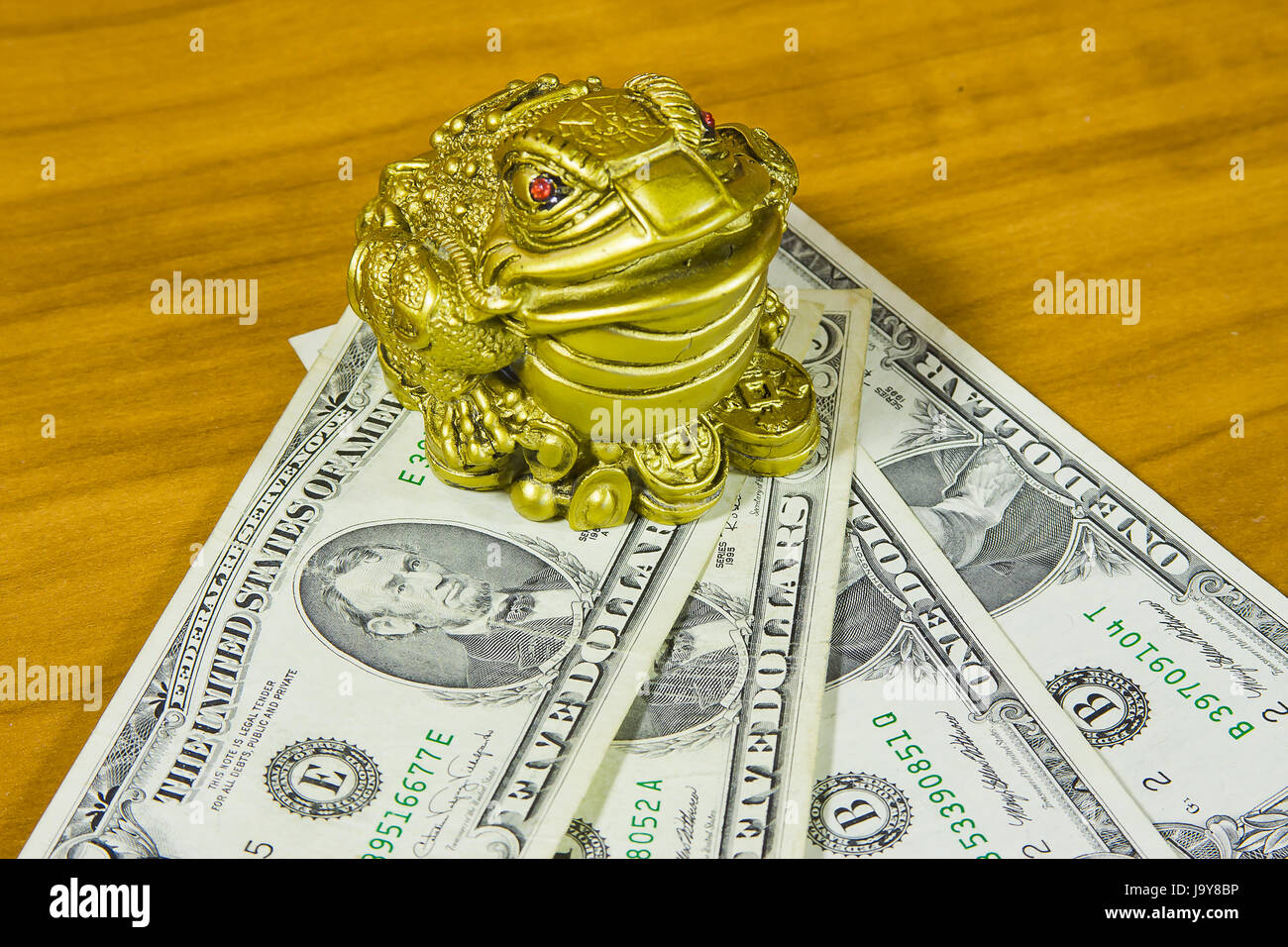 a souvenir is a frog and dollars Stock Photo - Alamy