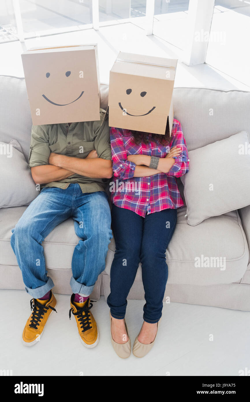 Silly employees wearing boxes on their heads with smiley faces on a ...