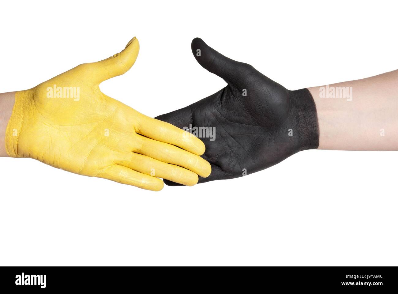 a handshake between a yellow and a black painted hand Stock Photo - Alamy