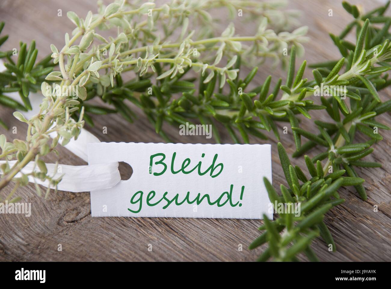 a white label with the german words Bleib gesund which means stay ...