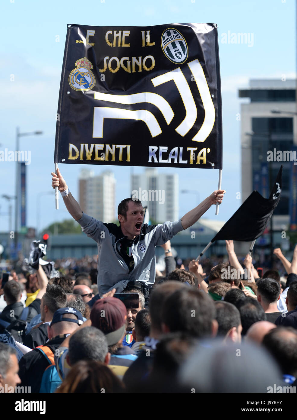 Fans line the street in cardiff ahead of the UEFA Champions League ...