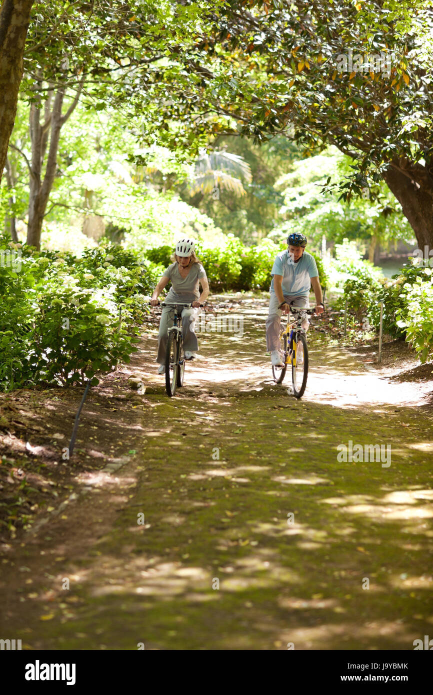 Elderly couple mountain biking outside Stock Photo - Alamy