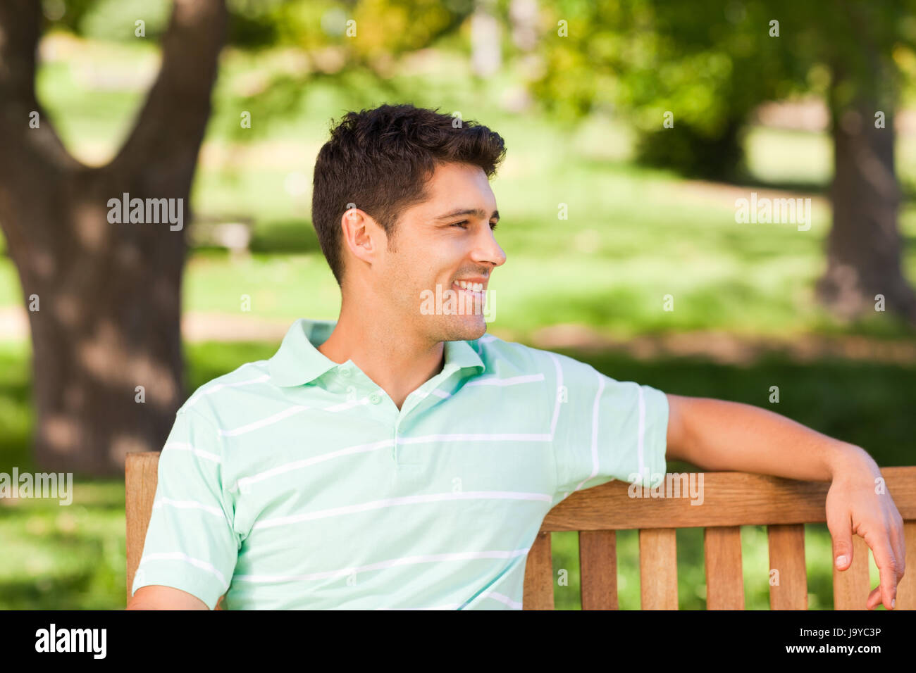 Man on the bench in a park Stock Photo - Alamy
