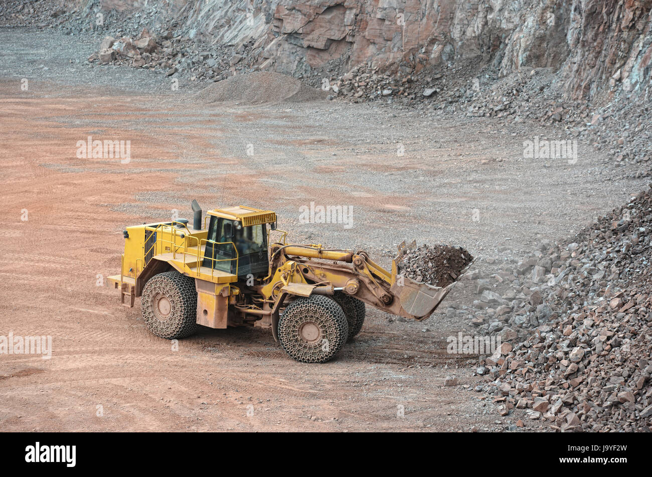 view into a porphyry mine. earth mover loading rocks Stock Photo - Alamy