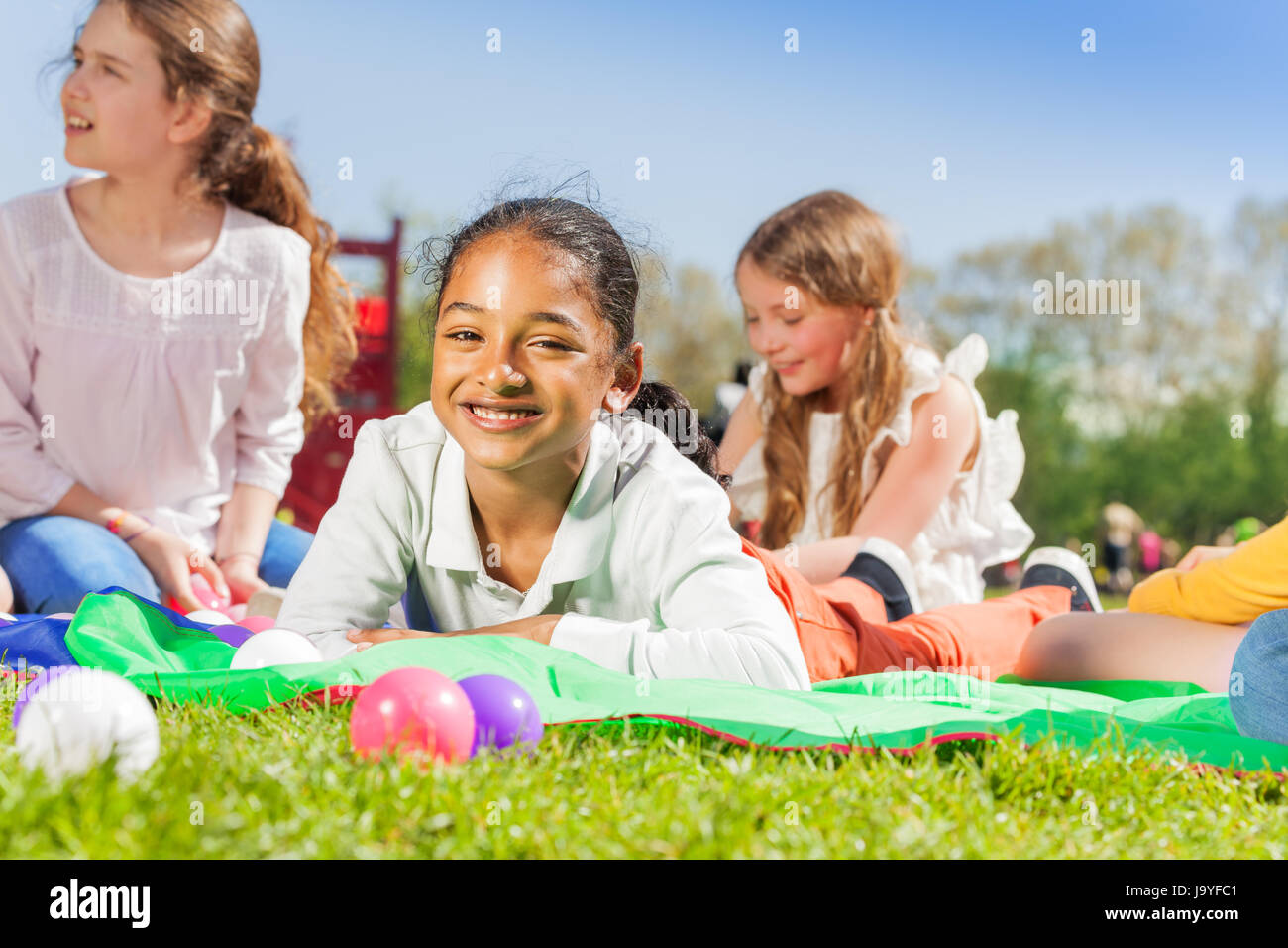 Smiling African boy having rest with her friends Stock Photo - Alamy