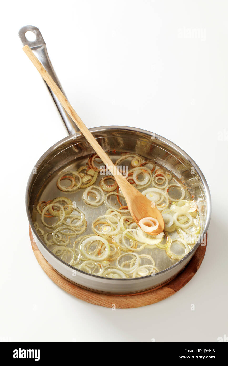 Frying onion rings in a pan - studio Stock Photo - Alamy