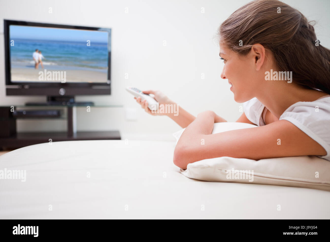 Young woman watching television Stock Photo - Alamy
