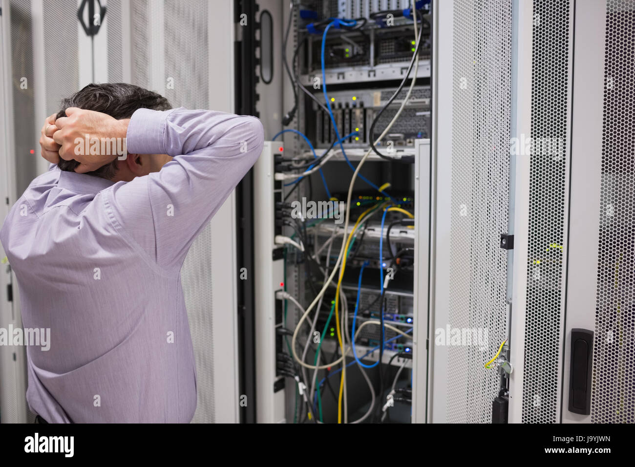 Technician feeling frustrated over server maintenance in data center ...