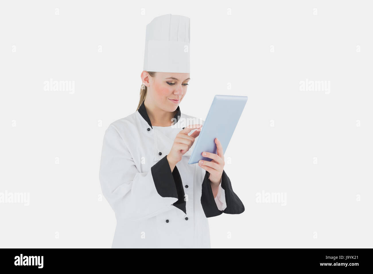 Female chef using tablet computer over white background Stock Photo - Alamy