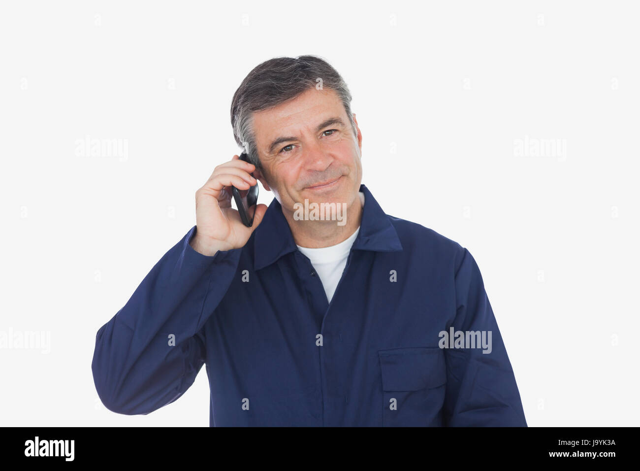 Portrait of mature mechanic on call over white background Stock Photo ...