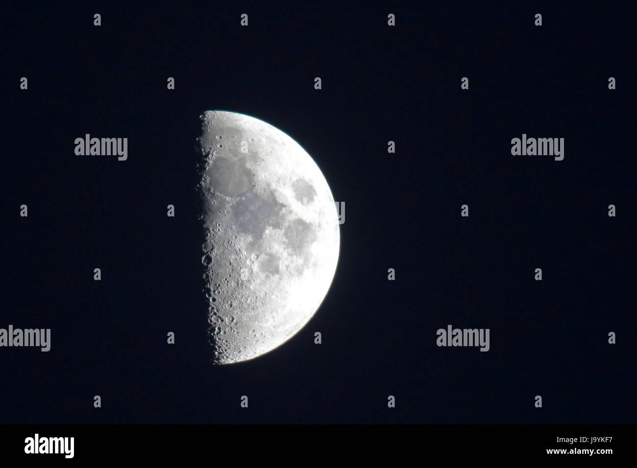 Half moon, the moon up close showing crater detail Stock Photo - Alamy