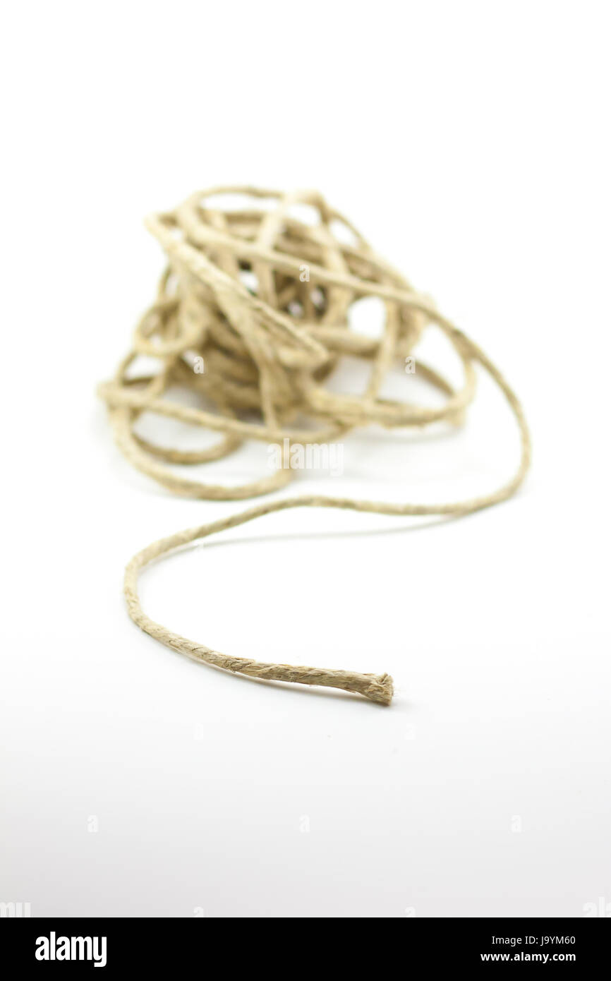 Tangled pile of twine with a single piece leading out Stock Photo - Alamy