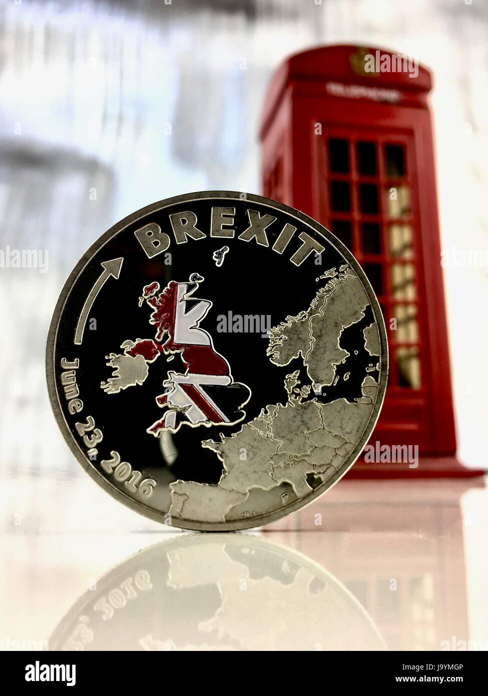 Physical silver brexit coin near red telephone box Stock Photo - Alamy
