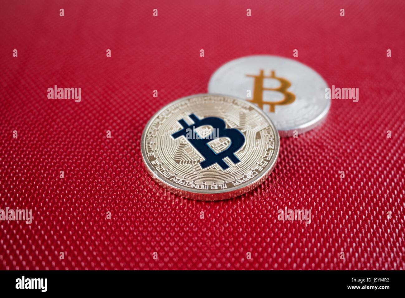 Digital currency physical gold and silver bitcoin on the red background ...