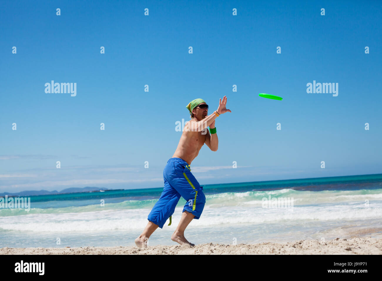 Playing frisbee on sunny beach hi-res stock photography and images - Alamy