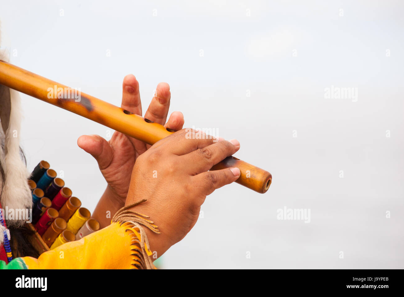 Peruvian Man In Native Costume Playing flute Stock Photo - Alamy