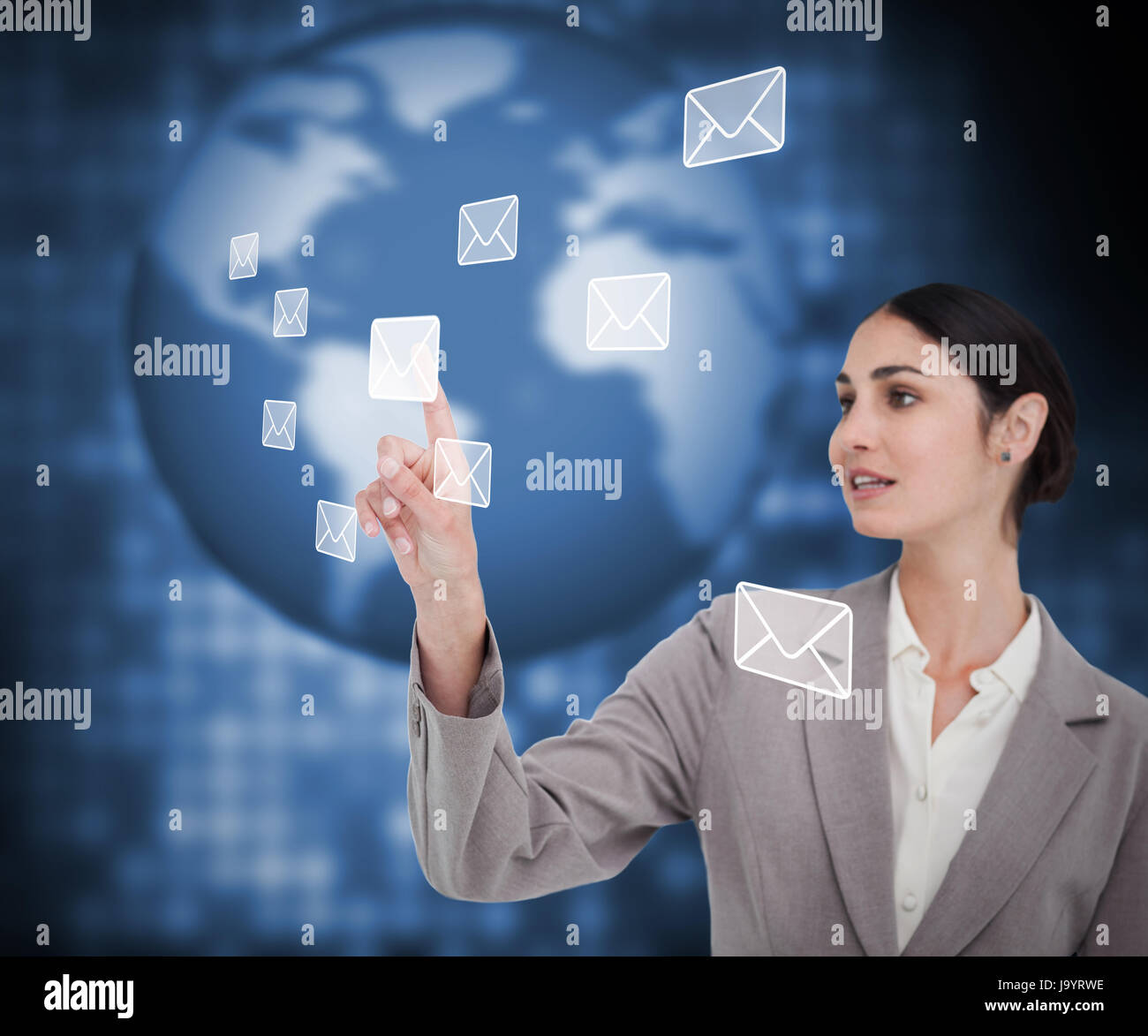 Brunette businesswoman pressing envelope on touch screen against ...