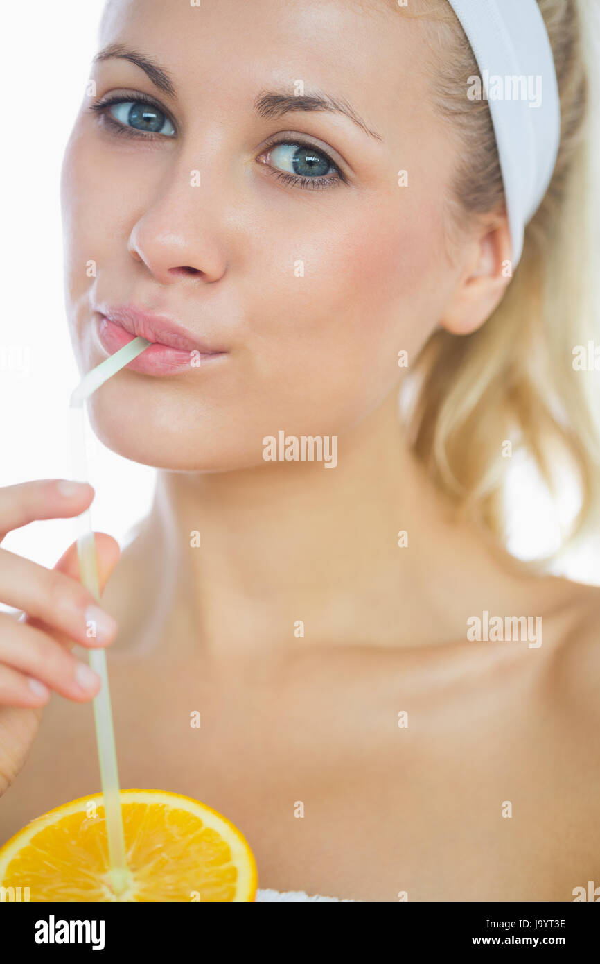 Closeup Portrait Of Beautiful Woman Drinking Orange Juice With Straw