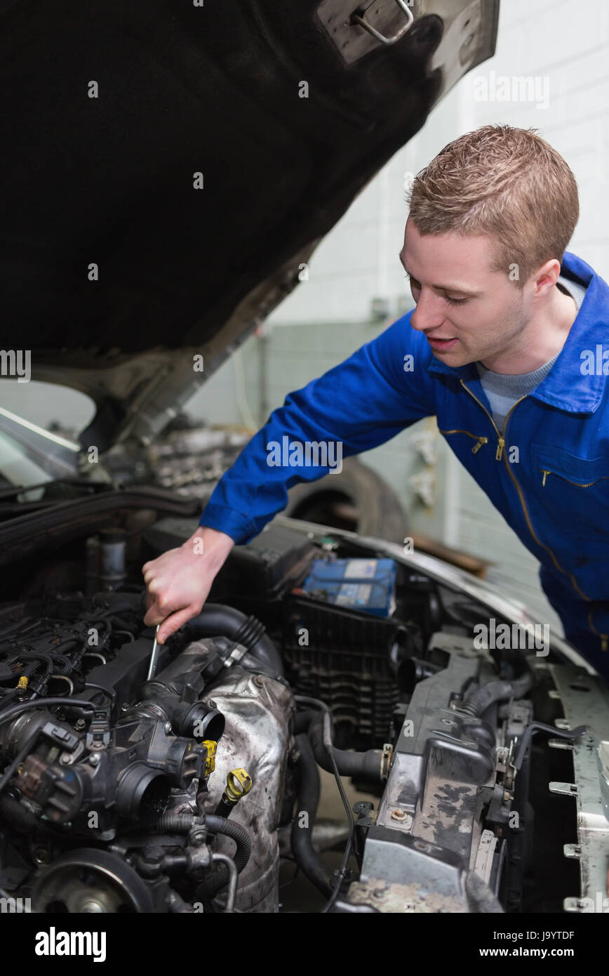 Young male mechanic working on car engine Stock Photo - Alamy
