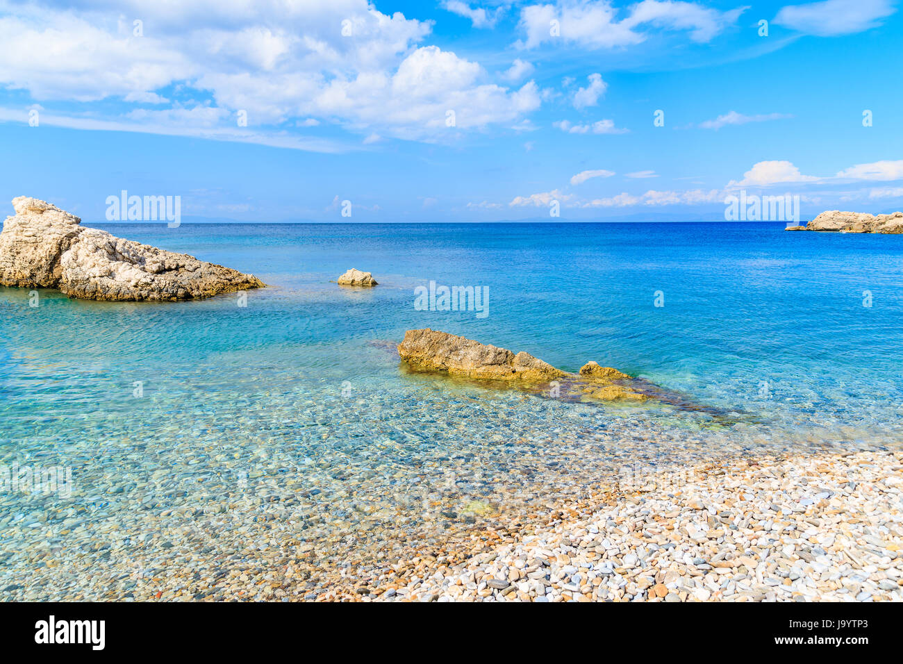 Beautiful pebble stone beach with rocks in Kokkari village on sunny ...