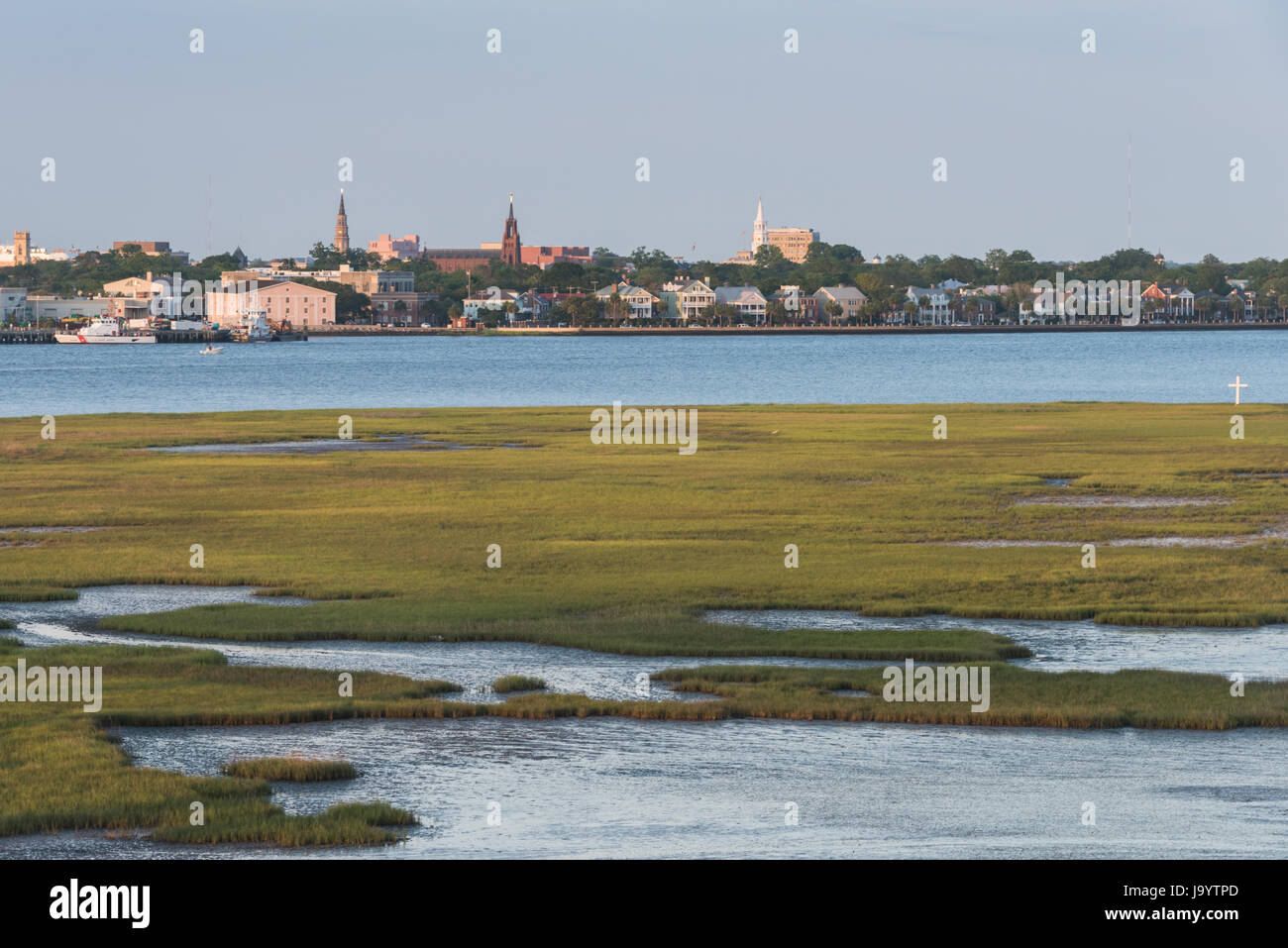 Saltwater marsh view and city skyline along the Ashley River at sunset ...