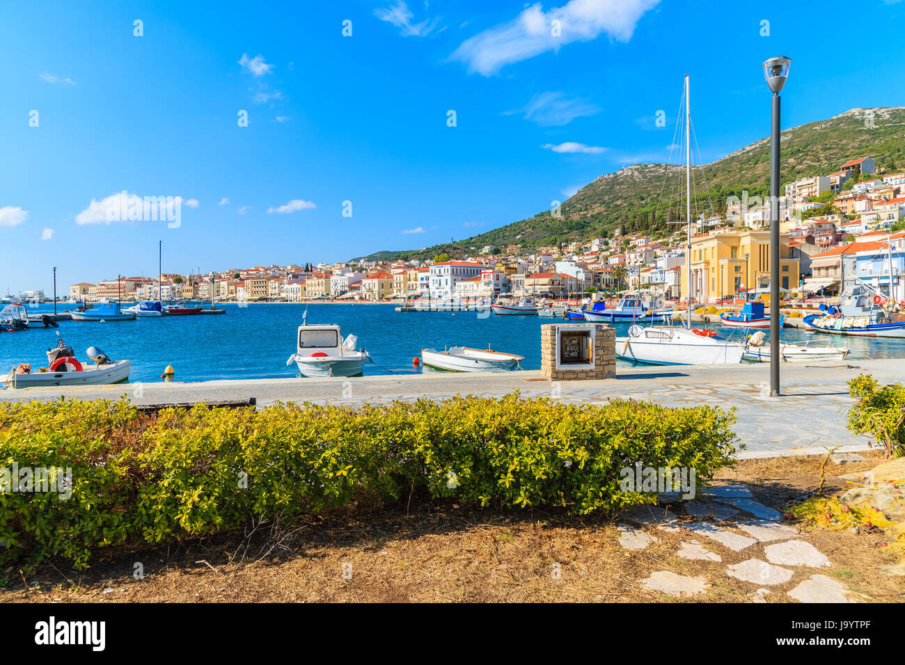 View of Vathy port with typical fishing boats and colourful houses on ...