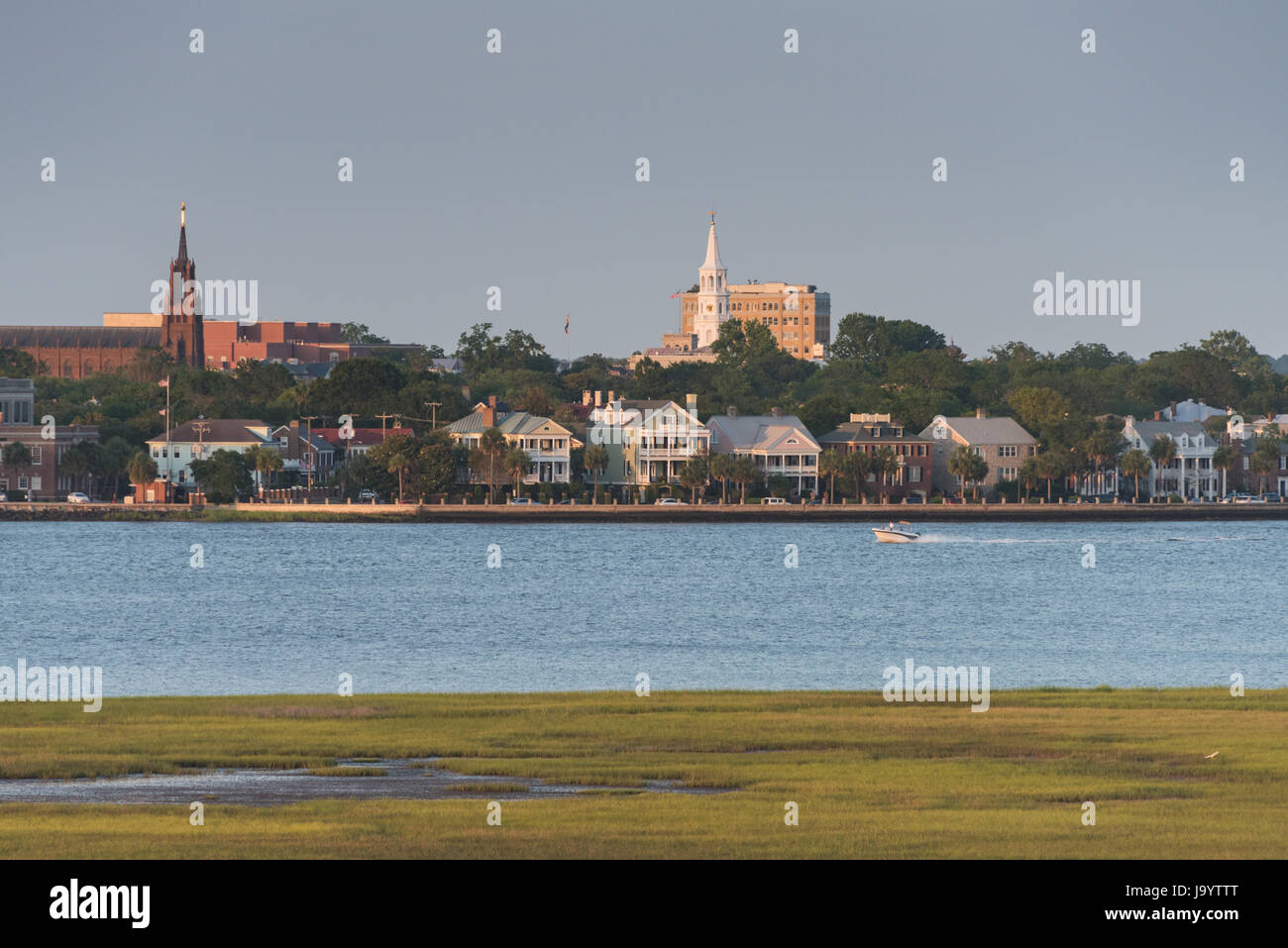 Saltwater marsh view and city skyline along the Ashley River at sunset ...