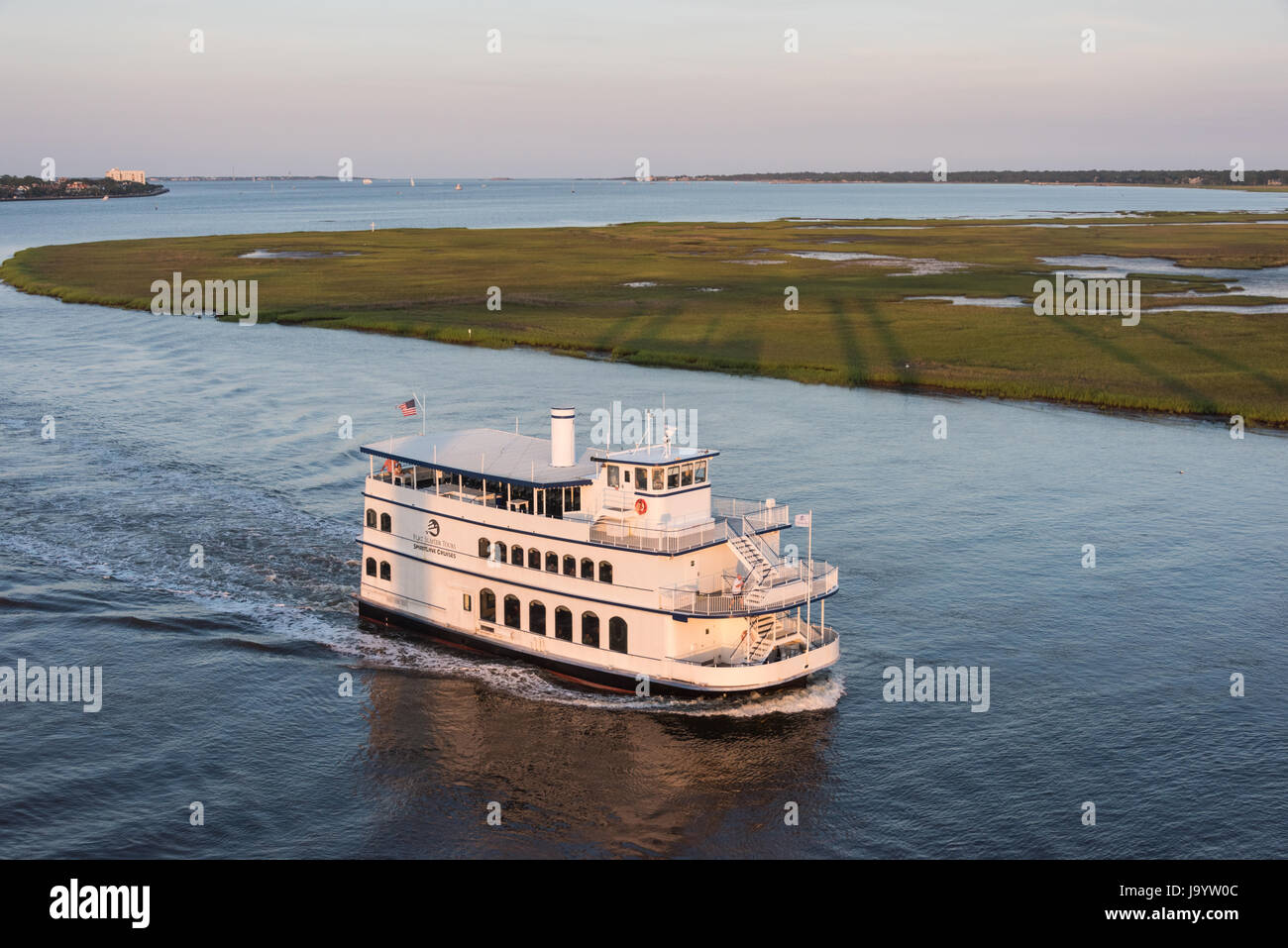 Sunset tour boat Spirit of Carolina crosses the Ashley River past the ...