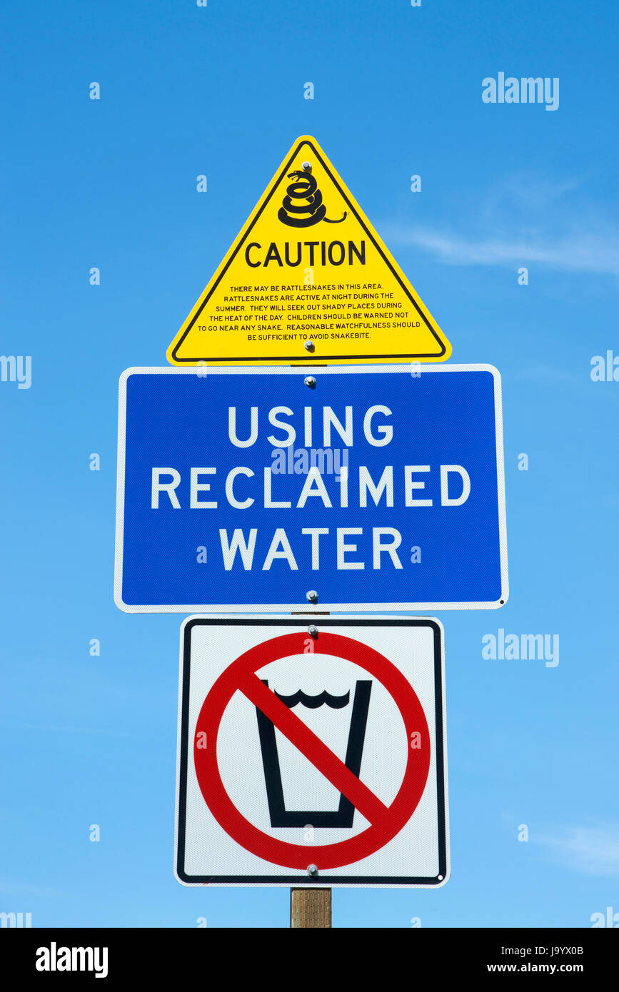 Multiple caution signs at a rest stop in central california. Snake ...