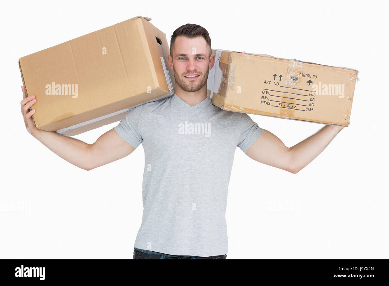 Portrait of young man carrying package boxes over white background ...
