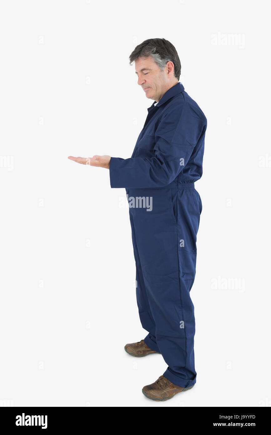 Side view of mature mechanic gesturing over white background Stock ...